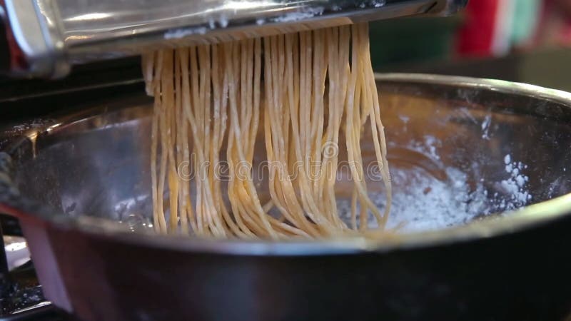 Close Up of the Process of Making Noodles Using a Hand Mill Stock ...