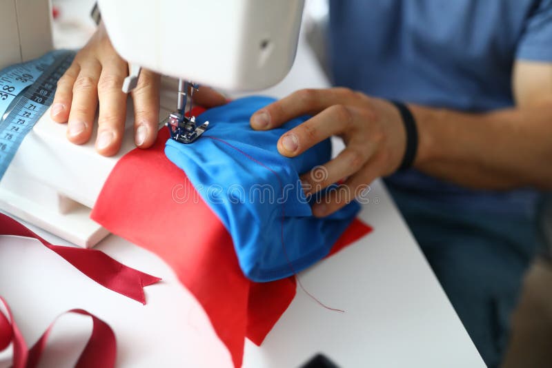 Close-up of Professional Atelier Worker Using Sewing Machine. Man in ...