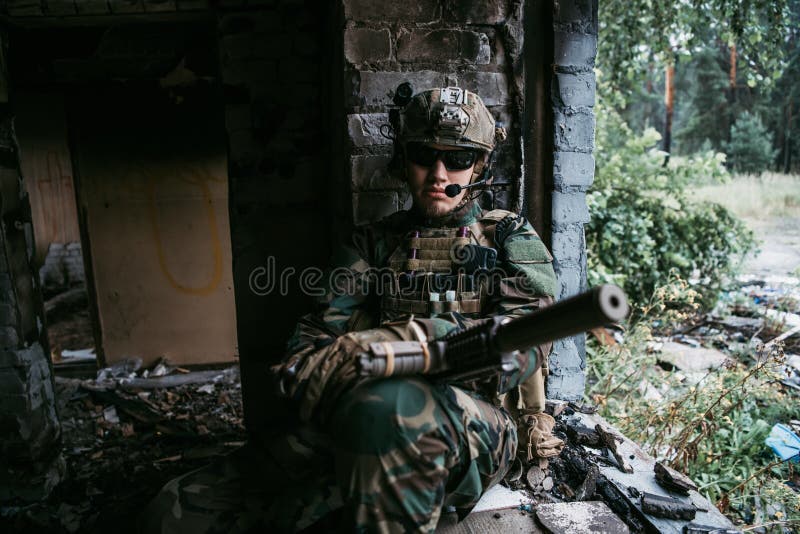 Close-up of a Professional Fully Equipped Soldier Looking at Camera ...