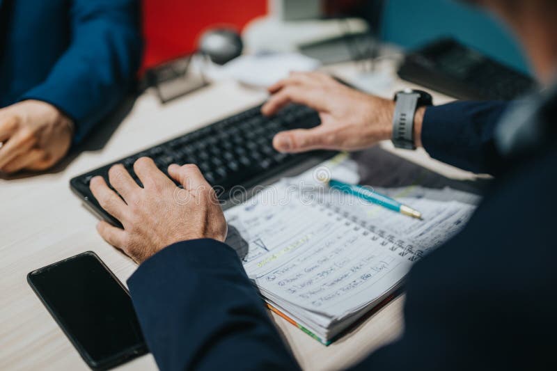 Business Professional Typing and Taking Notes during a Corporate Office ...