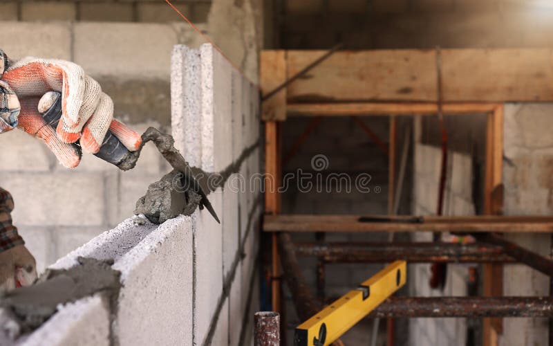 Close-up of Professional Workers Using a Pan Knife for Building Brick ...