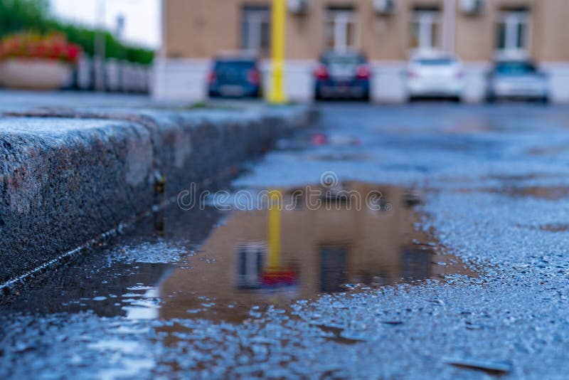 Close Up Puddle on the Asphalt with Reflections after the Rain in City ...