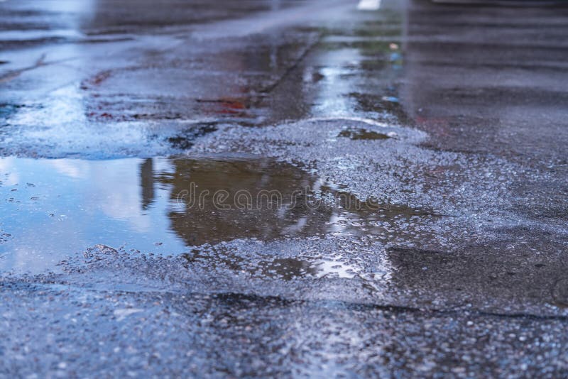 Close Up Puddle on the Asphalt with Reflections after the Rain in City ...