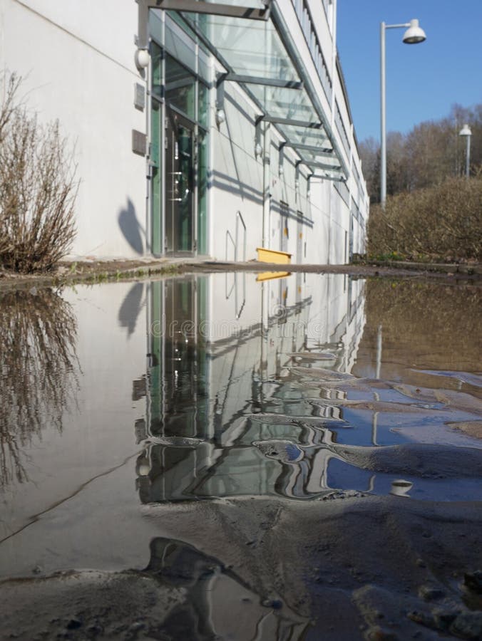 Close Up of a Puddle Next To a Building Stock Image - Image of ...