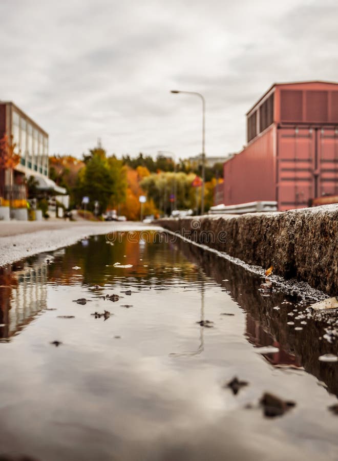 Close Up of a Puddle on Street Stock Photo - Image of covered, street ...