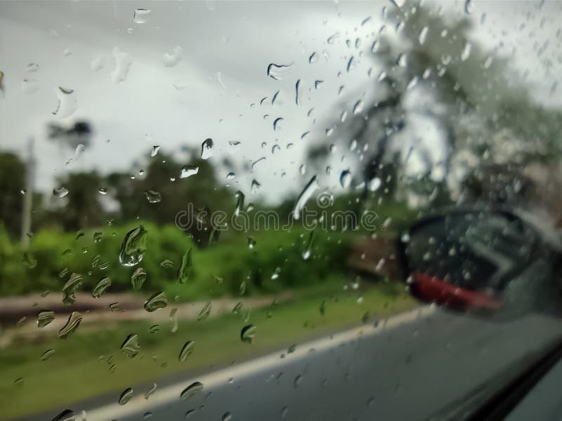 Close Up RainDrops on Car Window and Side View Mirror Background Stock ...