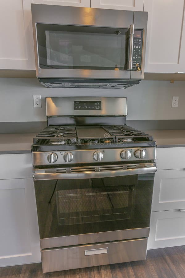 Close Up of a Range and Microwave Inside the Modern Kitchen of a House ...
