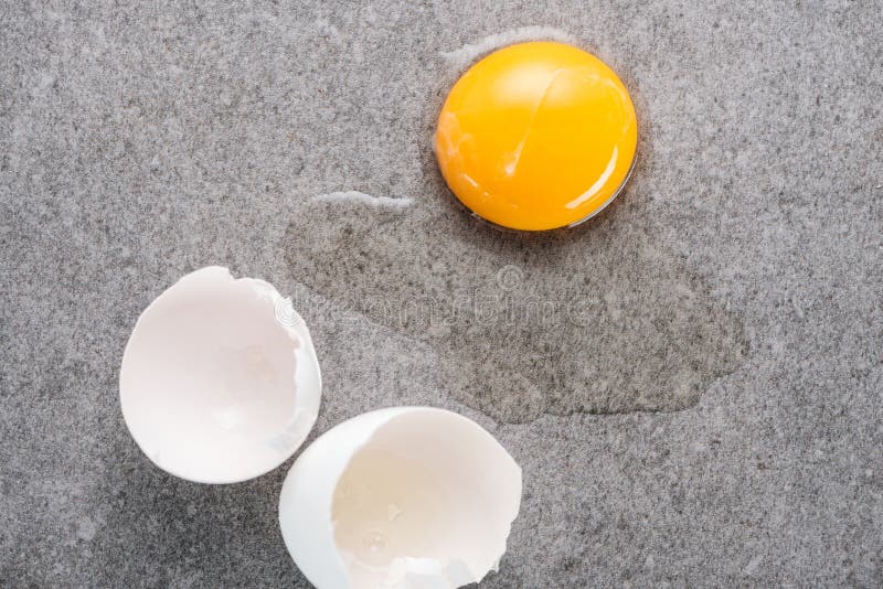 Close Up of Raw Smashed Egg with Yolk and Protein on Grey Background ...