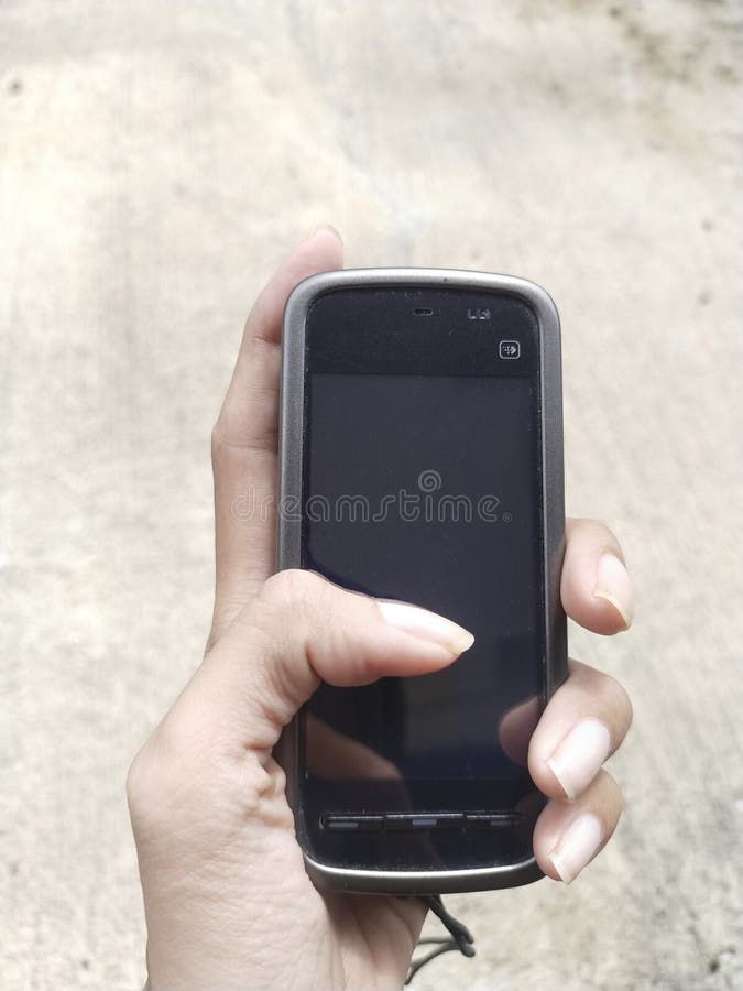 Close Up Real Photo Holding a Classic Black Touchscreen Cellphone with ...