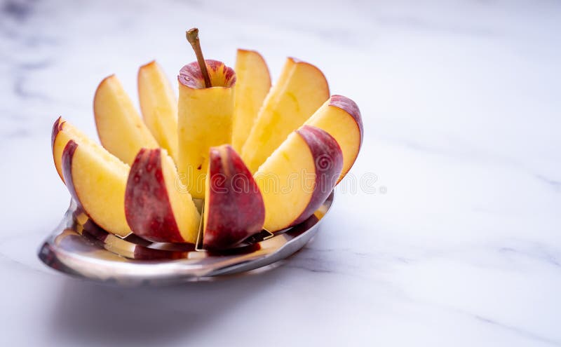 Juicy Red Apple Cut on To Segments Using Metal Apple Slicer Stock Image ...