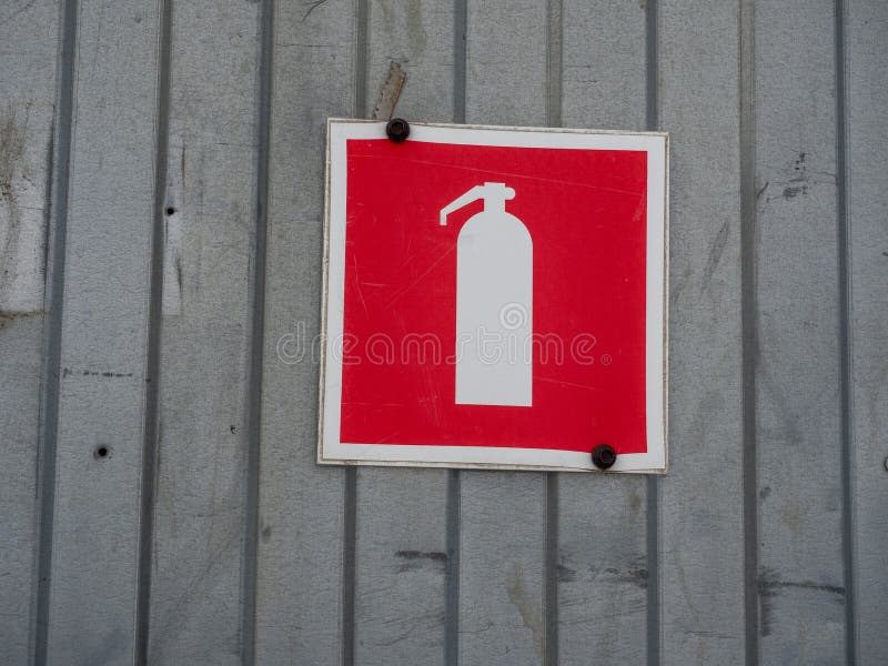 Close-up of the Red Fire Extinguisher Sign on the Metal Wall of the ...