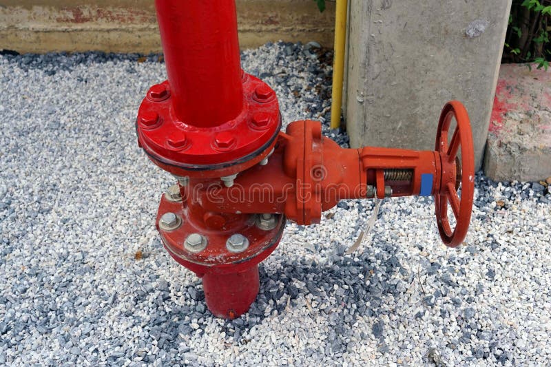 Close Up of the Red Fire Hydrant Valve on the Ground Stock Photo ...