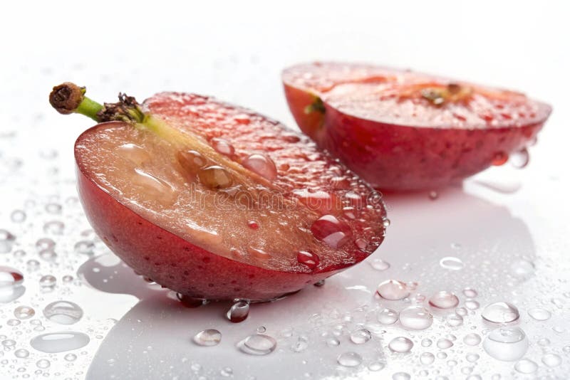 Close-Up of Red Grape Slice with Water Drops on White Background Stock ...
