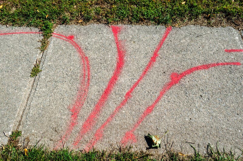 Close-up of Red Hydro Line Markings on a Sidewalk Stock Photo - Image ...