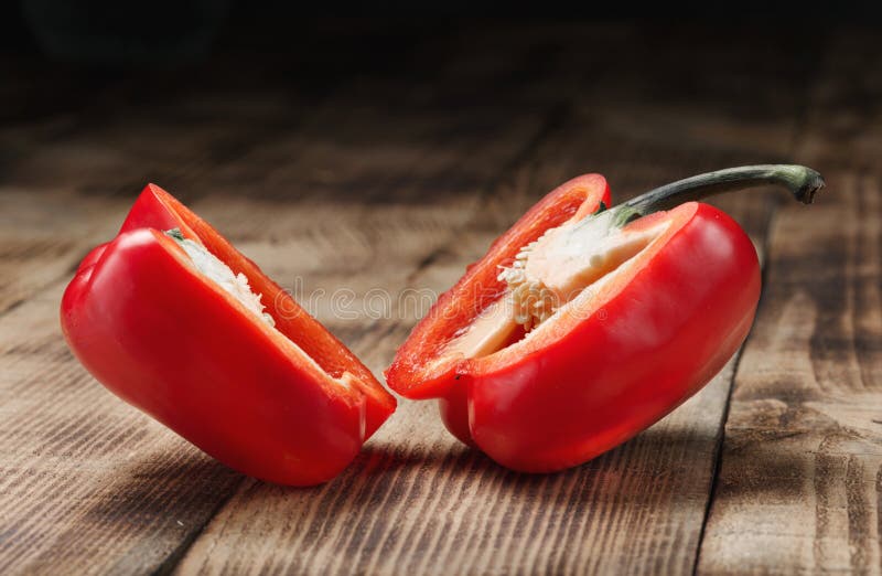 Red Pepper Cut into Two Pieces on Wooden Cutting Board Stock Photo ...