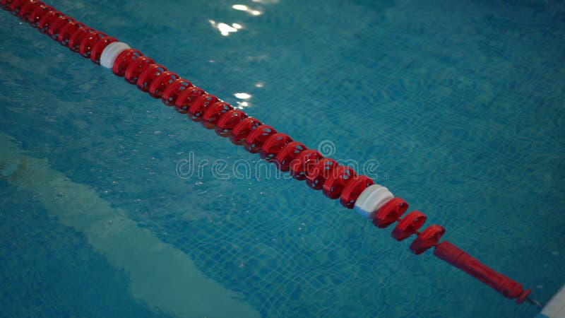 Close-up of a Red Pool Dividing Path on the Water Surface of the Pool ...
