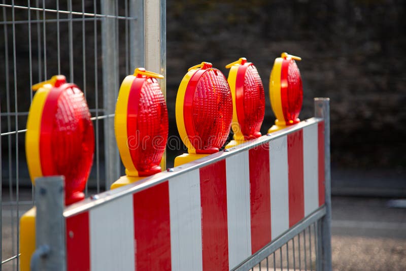Close-up of Red Warning Lights with Street Barriers at a Construction ...