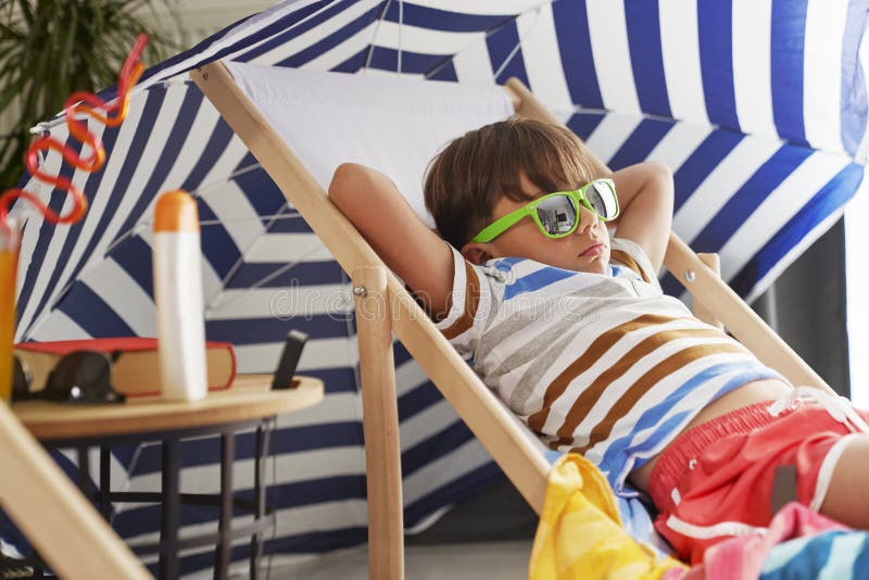 Close Up of Relaxed Boy Lying on a Chair at Home Stock Image - Image of ...