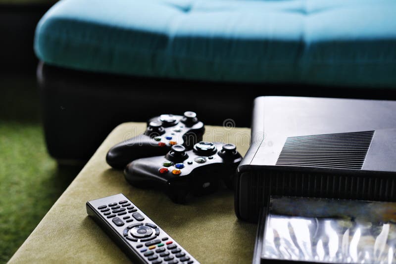 Close-up of Remote Control, Game Console and Disc Packaging on Table in ...