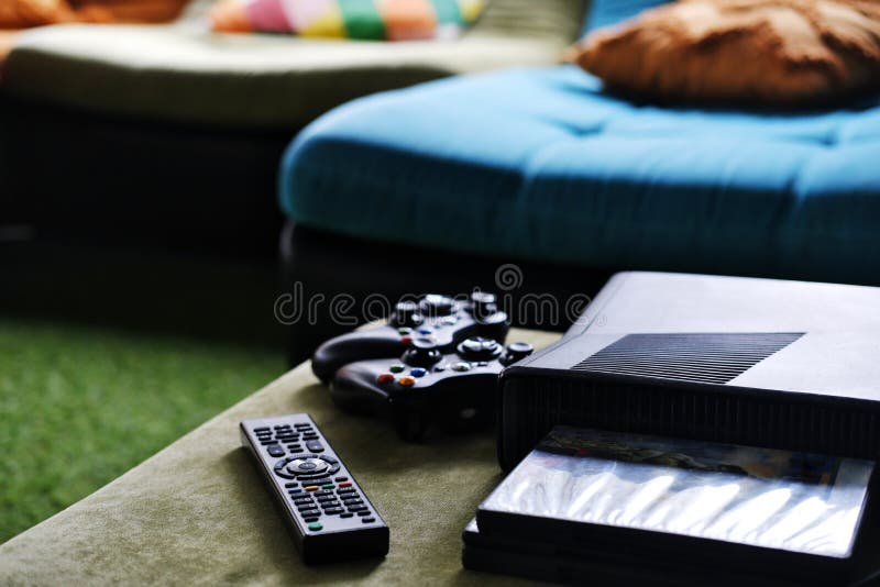 Close-up of Remote Control, Game Console and Disc Packaging on Table in ...