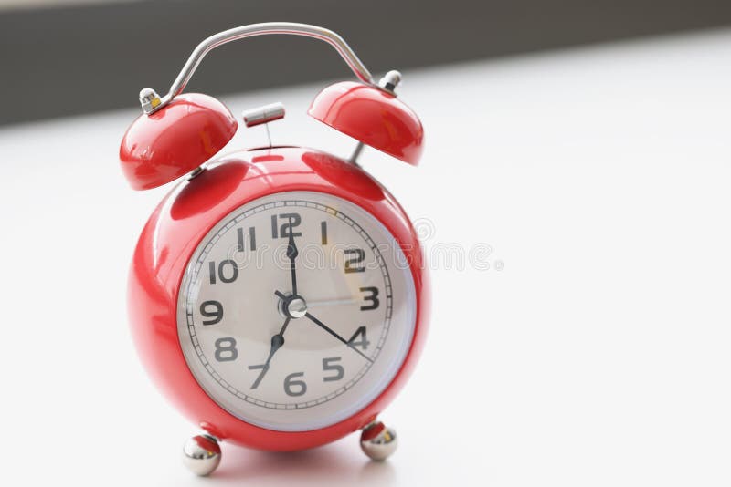 Retro Red Clock on White Surface Show Seven in Morning, Wakeup, Time ... Retro Red Clock on White Surface Show Seven in Morning, Wakeup, Time ...