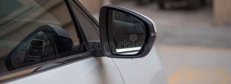 A Partial Close-up of the Right Side Mirror of a White Citroen C5 ...