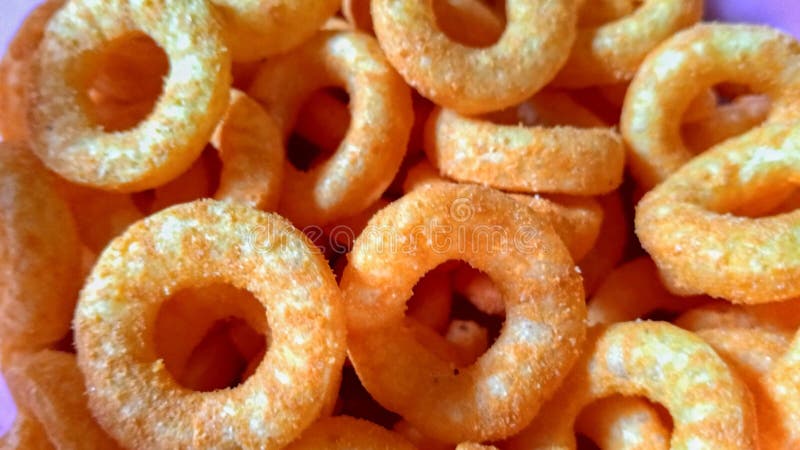 Close Up of a Ring-shaped Snack with a Cheese Flavor that is Crispy and ...