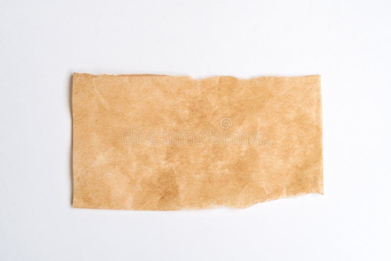 Close Up of a Ripped Piece of Brown Paper on White Background Stock ...