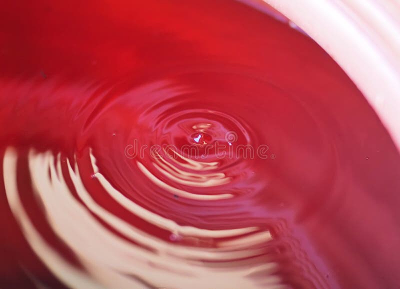 Close-Up of Ripples in Red Liquid Creating Concentric Patterns Stock ...
