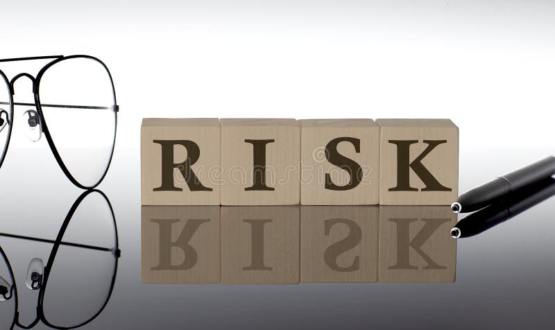 Close-up of RISK Wooden Blocks on the Black Background with Glasses and ...