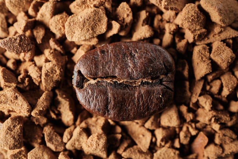Close-up of Roasted Coffee Bean Against the Background of Granulated ...