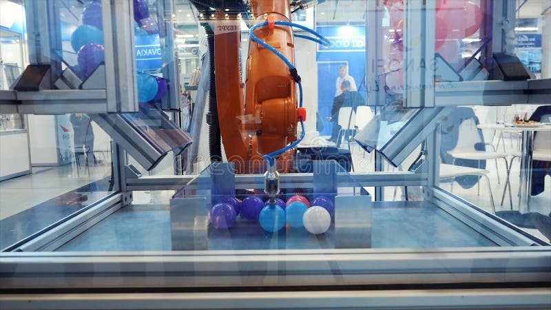 Close-up of Robotic Machine Hand Relocating Small Plastic Multicolored ...