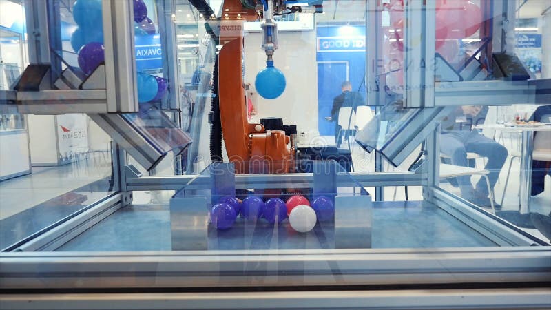 Close-up of Robotic Machine Hand Relocating Small Plastic Multicolored ...