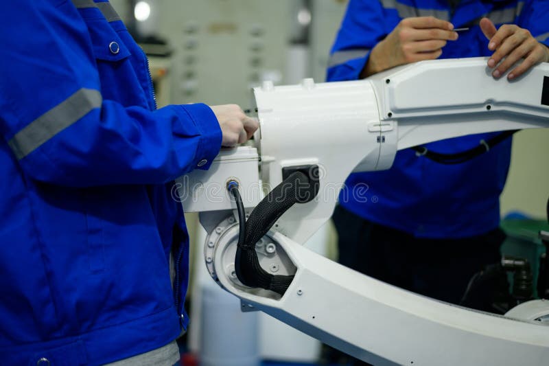 Close Up Of Robotics Engineers Using Controller To Remotely Operate Programming And Manipulating
