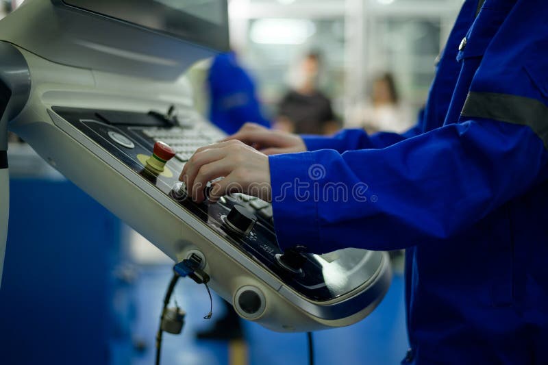 Close Up Of Robotics Engineers Using Controller To Remotely Operate