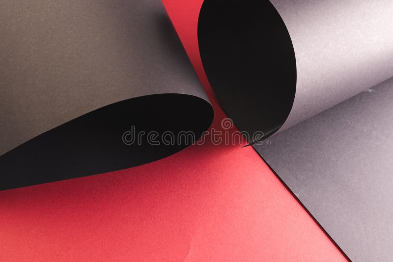 Close Up of Rolled Up Pieces of Black Paper with Copy Space on Red ...