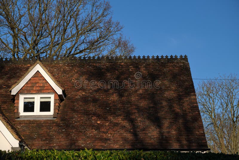 Close-up of the Rooftop with Attic Window of a Beautiful Cottage House ...