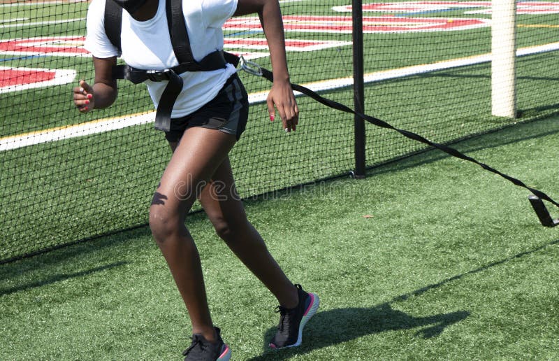Close Up of a Runner Pulling a Sled on a Turf Field for Strength Stock ...