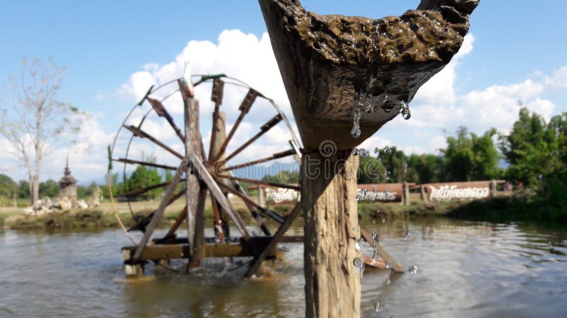 Rustic Water Wheel with Water Dripping in a Serene Countryside ...