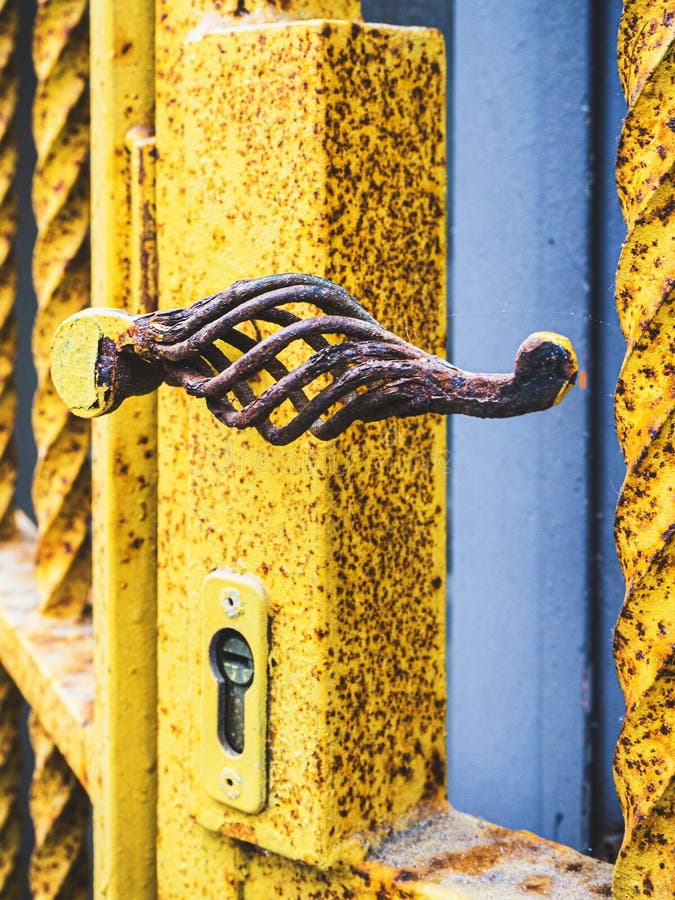 Close-up of a Rusty Decorative Handle on a Yellow Metal Gate Stock ...
