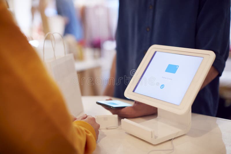 Close Up of Sales Assistant Accepting Contactless Payment in Shop from ...