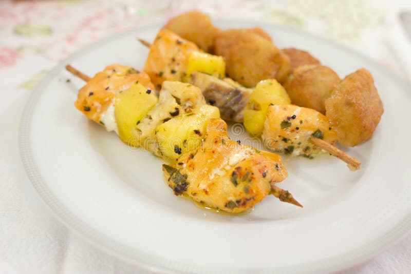Close Up of Salmon, Pineapple and Codfish Spiedini with Chips Stock ...