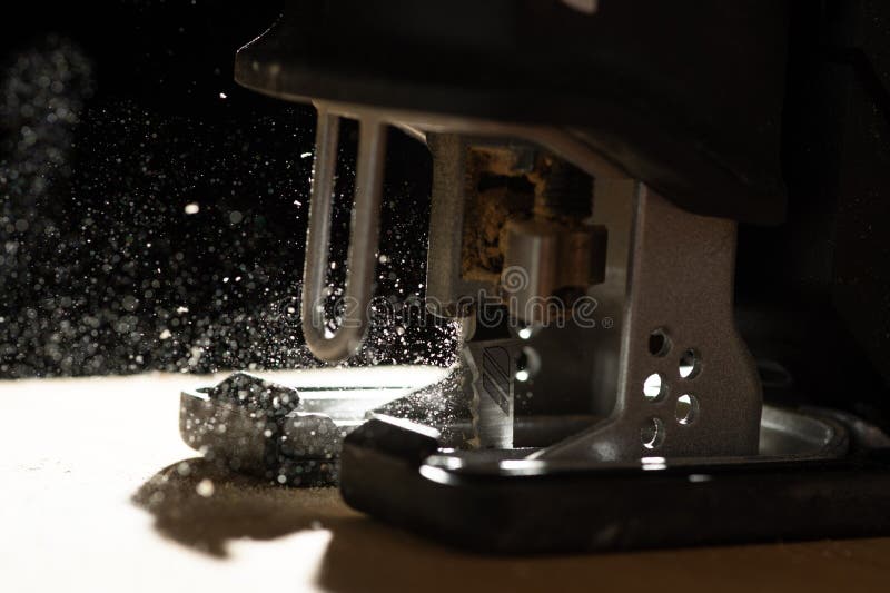 Close-up of Sawing Wood Slab with Jigsaw. Dust Particles are ...