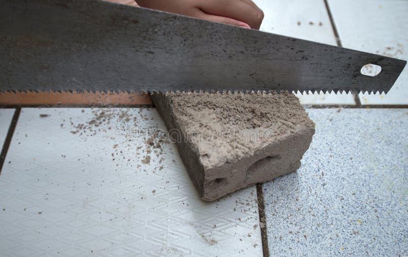 Close Up Saws Cutting Concrete Blocks Placed on a Ceramic Tile ...
