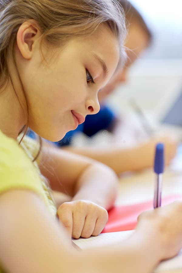 Close Up of School Kids Writing Test in Classroom Stock Image - Image ...