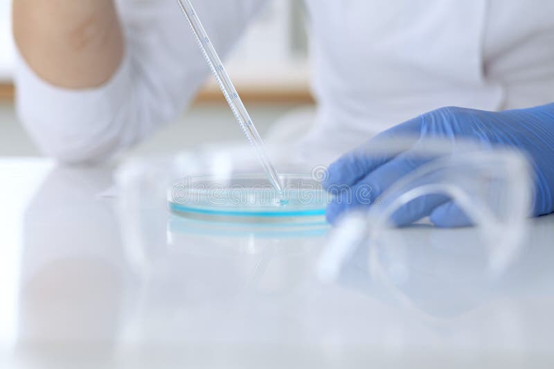 Close Up of Scientific Research Hands with Clear Solution in Laboratory ...