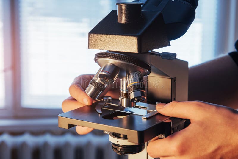 Close-up of Scientist Hands with Microscope, Examining Samples. Stock ...