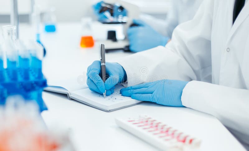 Close Up. Scientist Recording the Results of the Study in a Laboratory ...