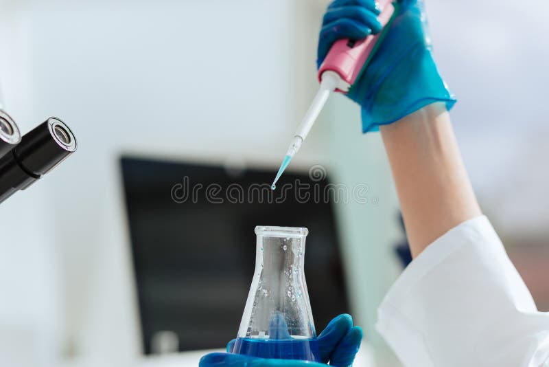Close Up. Scientist Testing a Liquid in a Laboratory Bottle Stock Photo ...