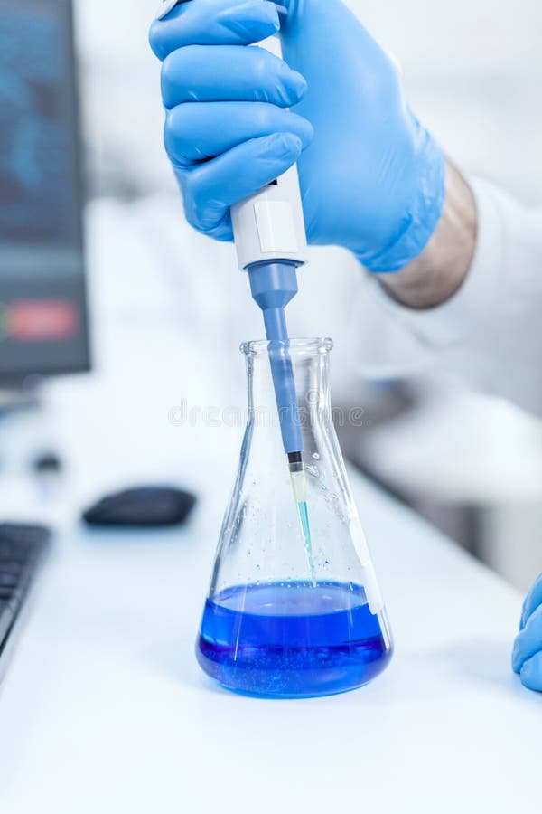 Close Up of Scientist Testing Liquid in Laboratory Flask Stock Image ...